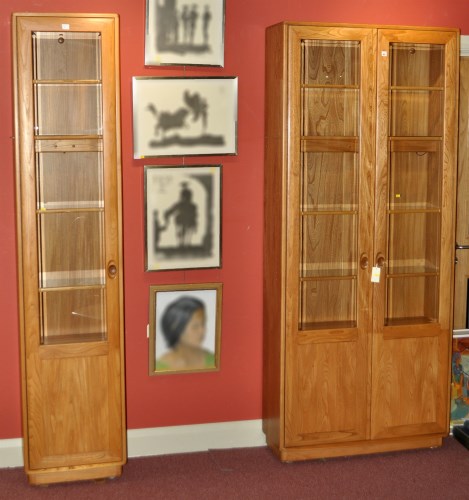 Lot 91 - Two Ercol Windsor light elm wall units, the