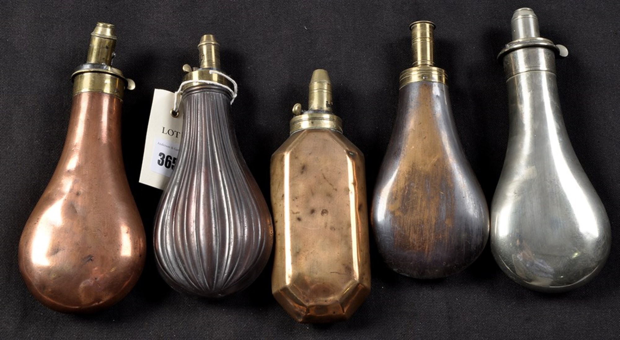 Five 19th Century powder flasks: four - auctions & price archive