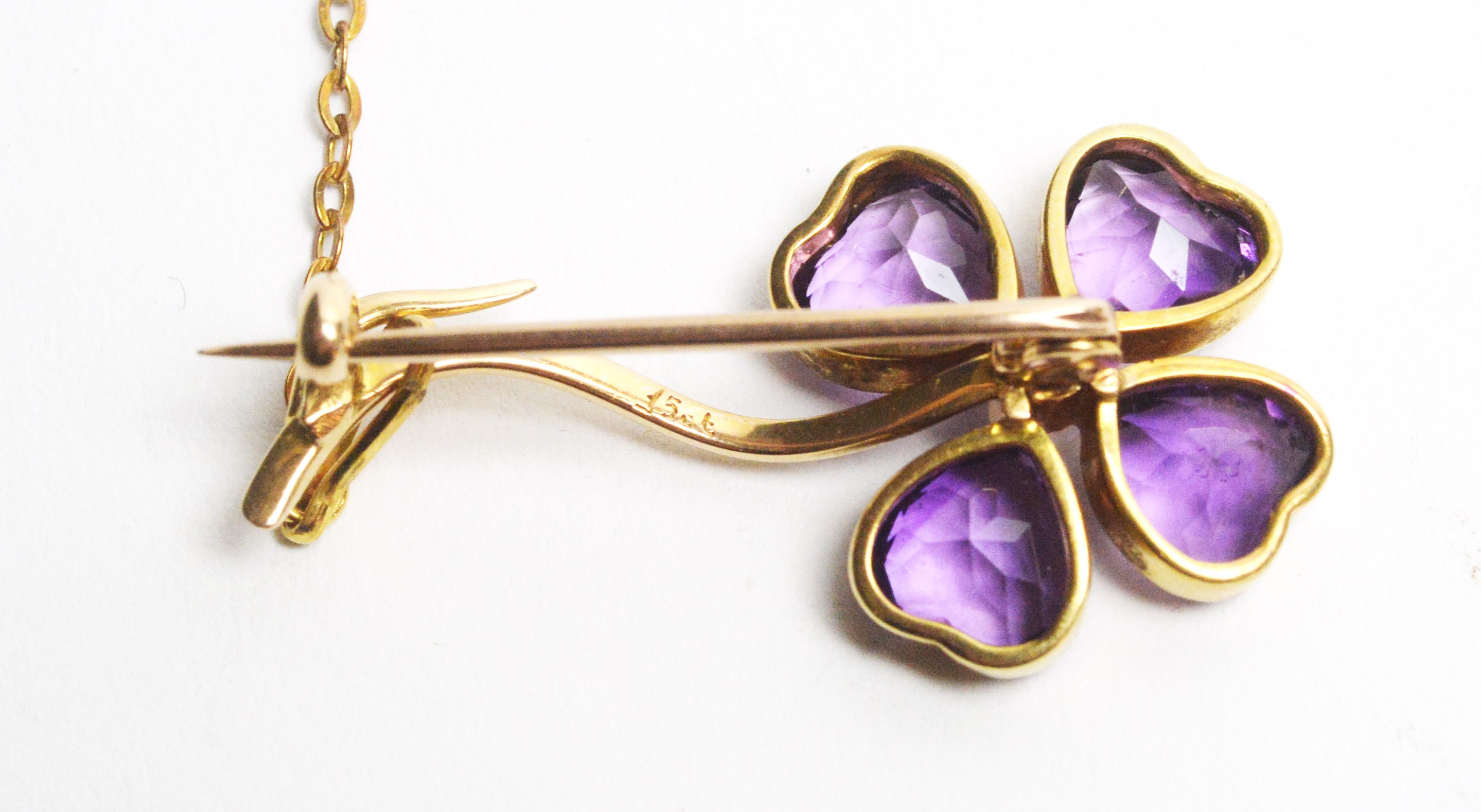 Lot 35 - An amethyst and pearl flower pattern brooch