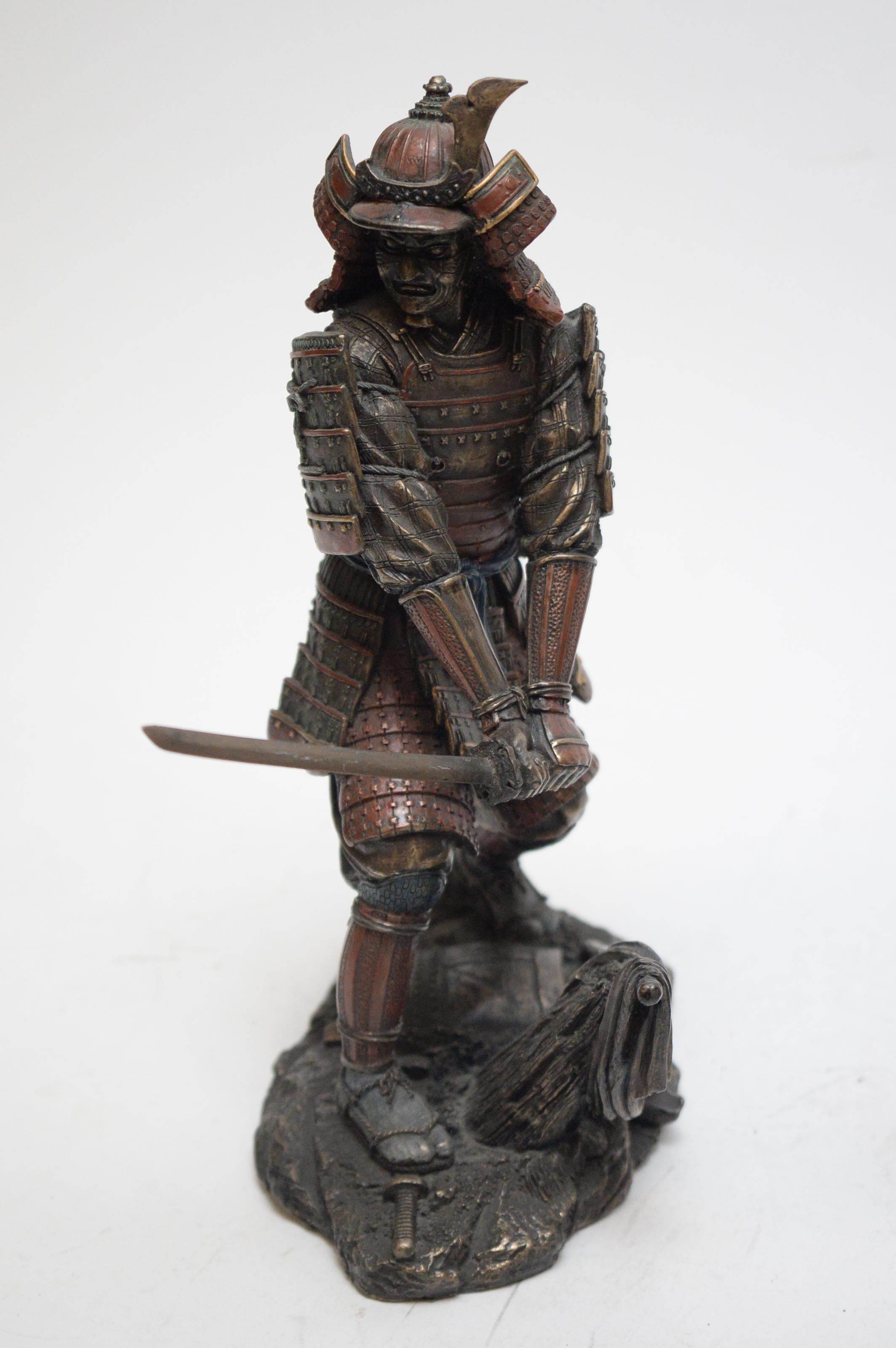 Lot 541 - Three Samurai Warrior figures.