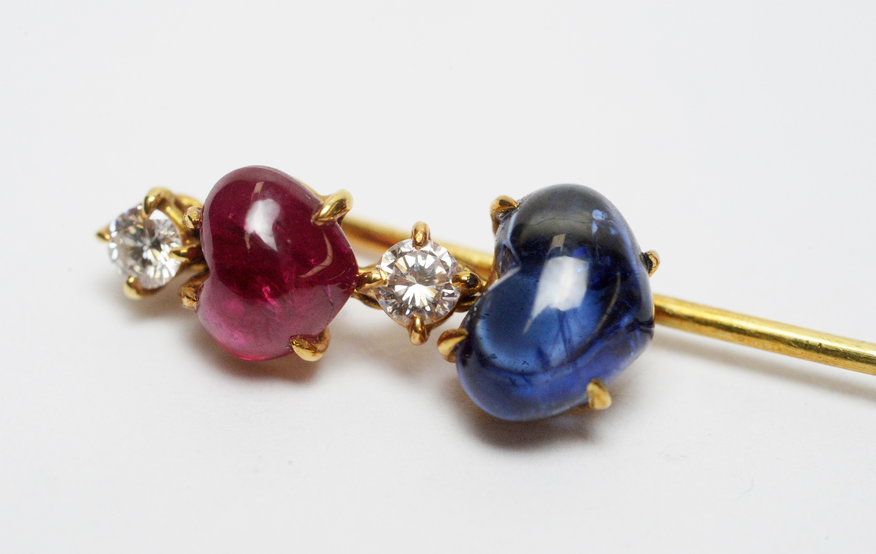 Lot 112 - A sapphire, diamond and ruby tie pin