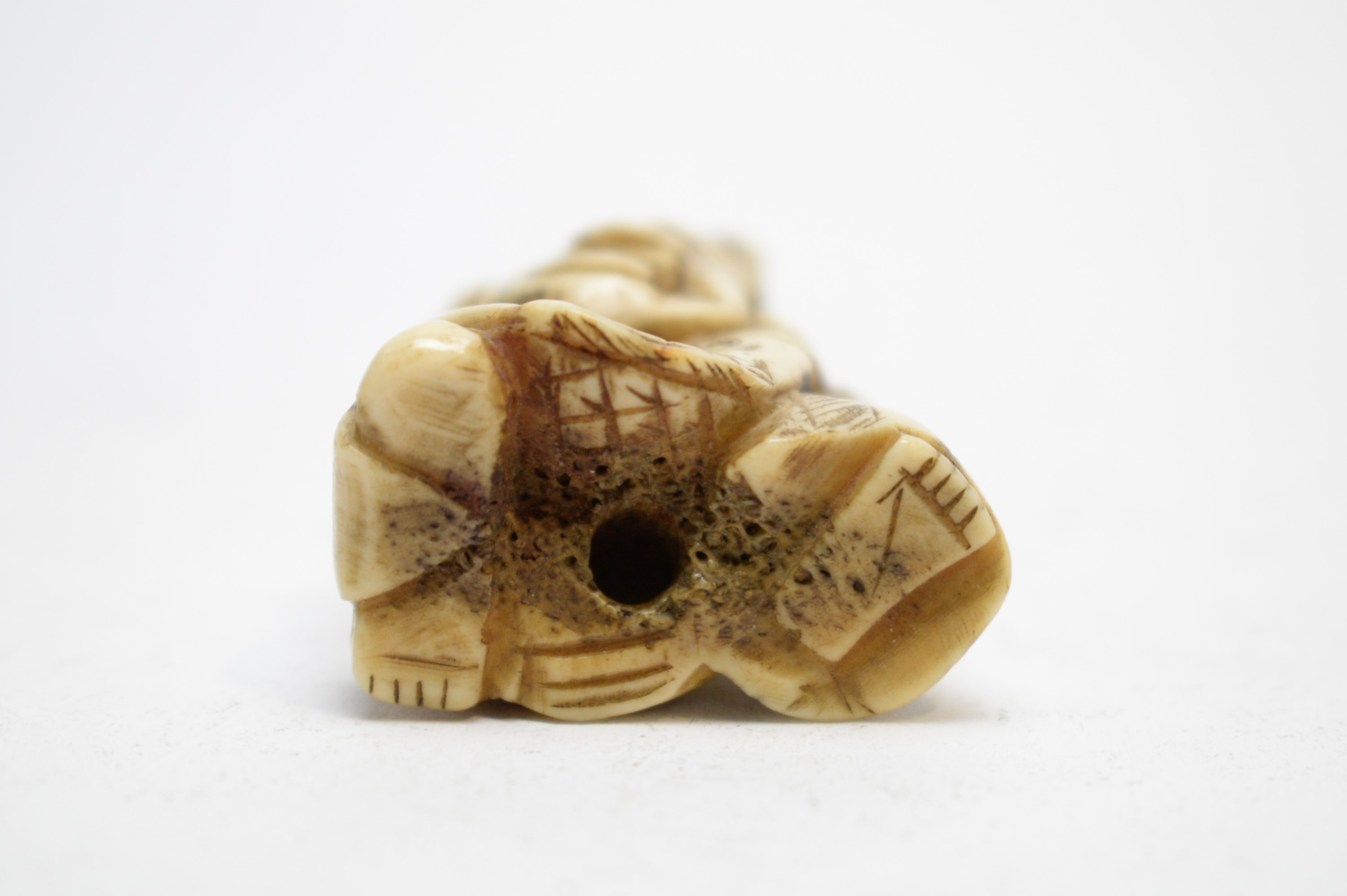 Lot 260 - Two Japanese netsuke and a toggle