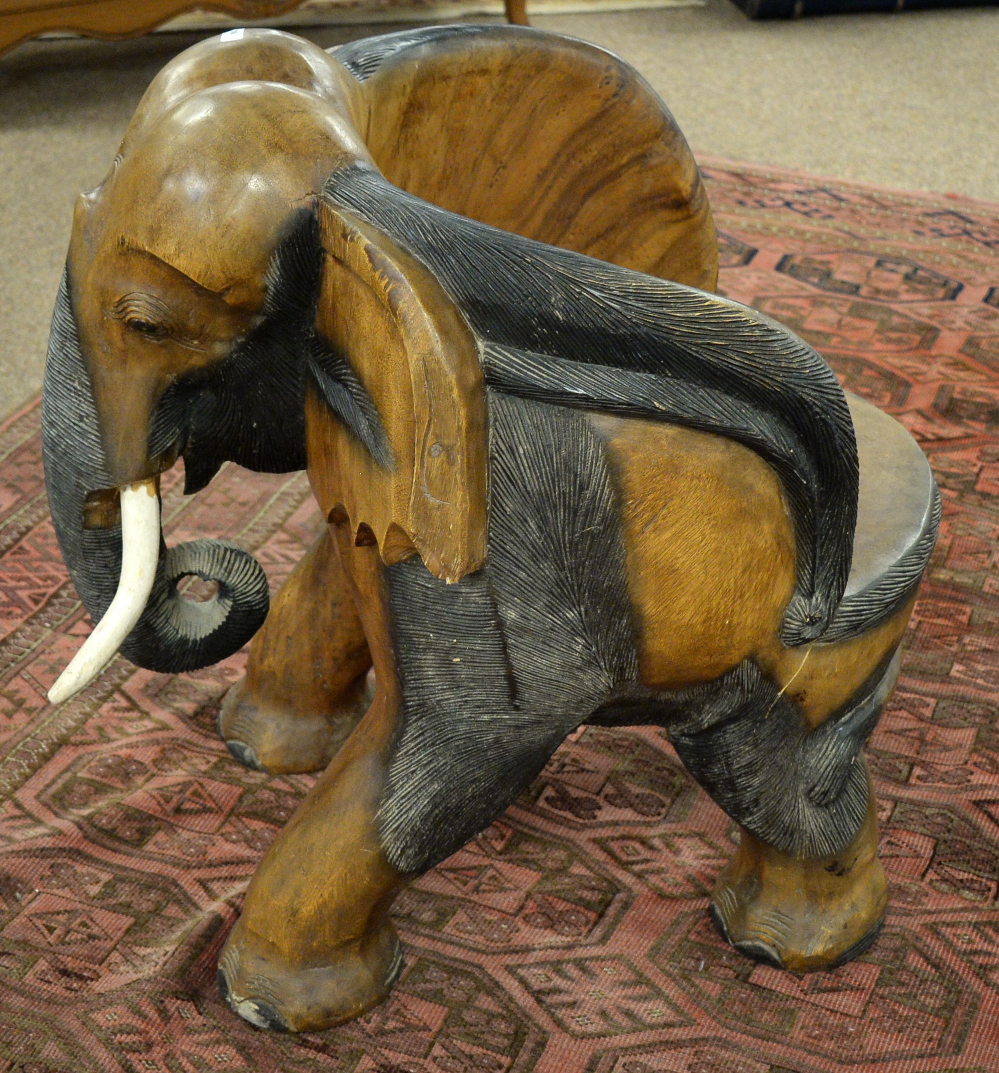 Lot 106 - An African carved elephant chair.