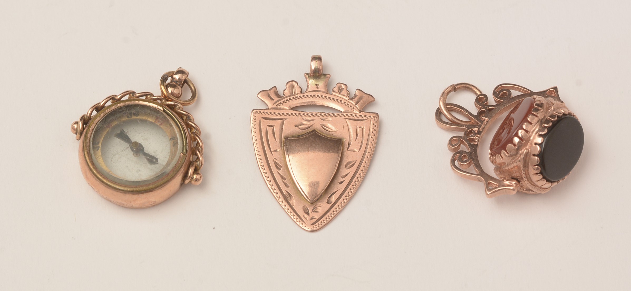 Lot 142 - Three 9ct gold fobs
