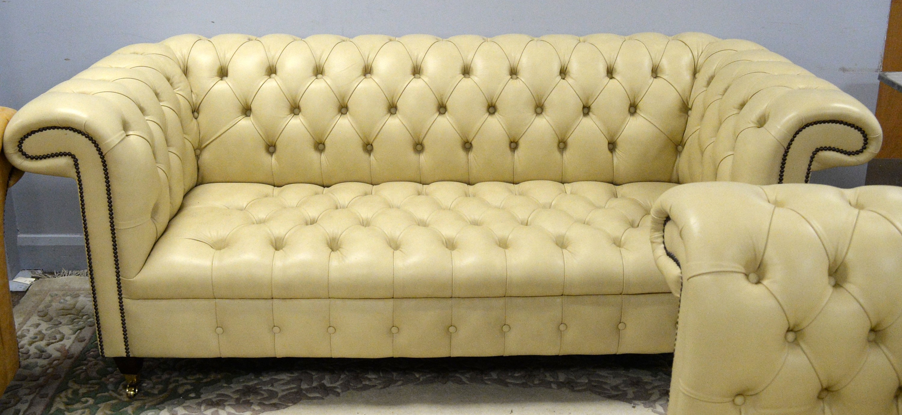 Lot 53 - A modern cream Chesterfield style sofa and a