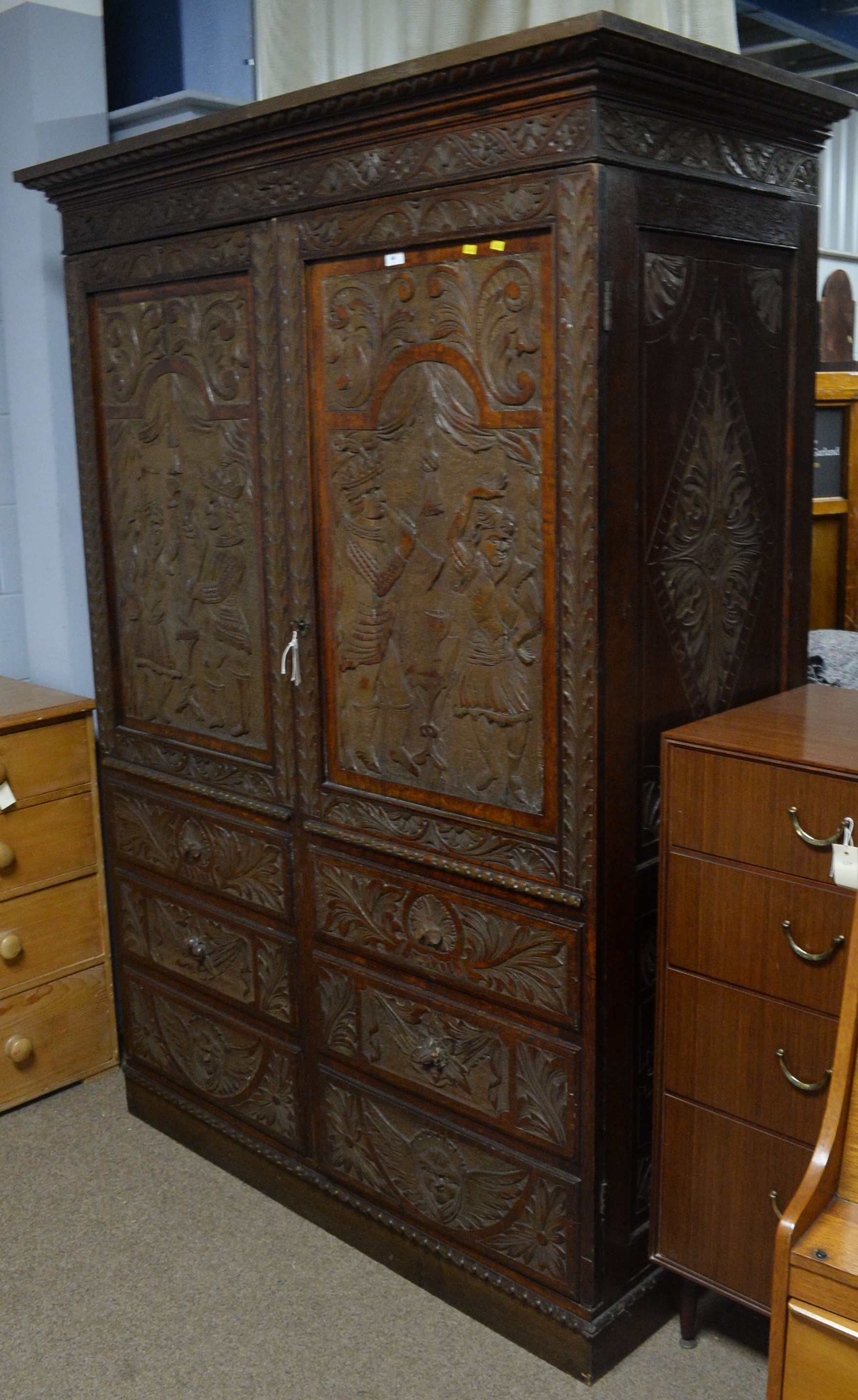 Lot 66 - A profusely carved oak wardrobe, basically