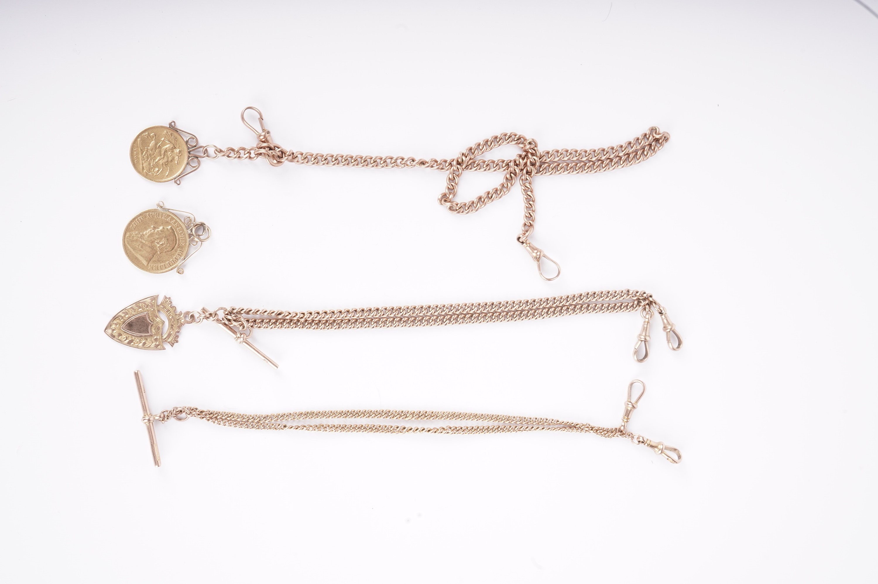 Lot 1129 - Three 9ct rose gold curb-link watch chains