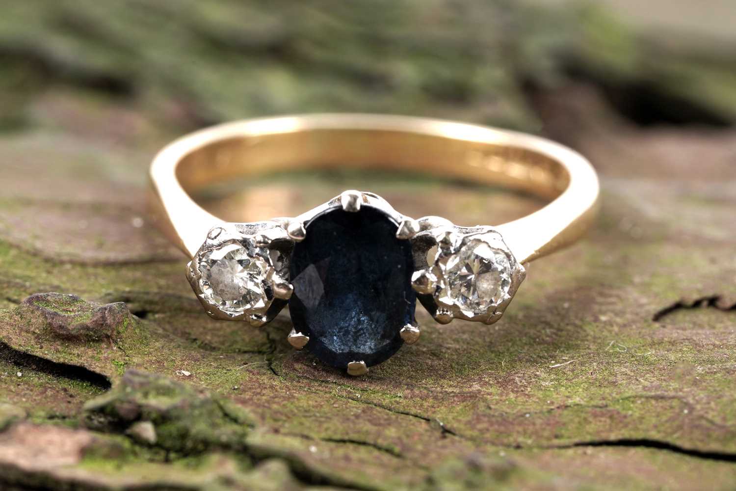 Lot 86 - A sapphire and diamond three-stone ring