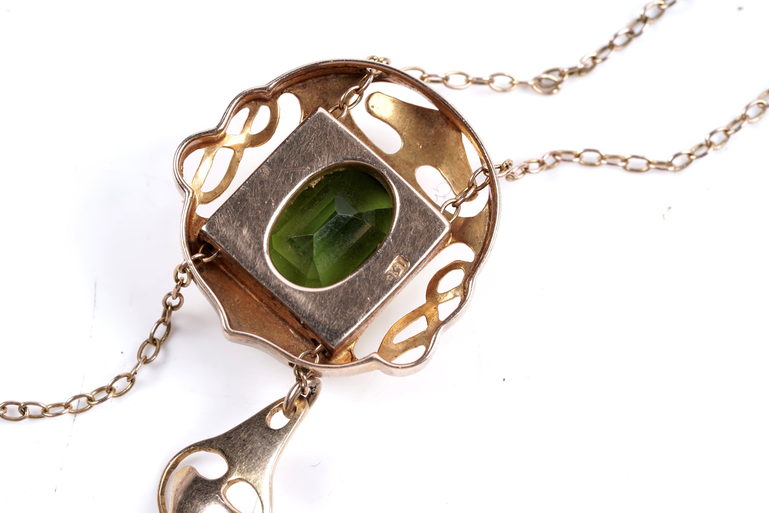 Lot 872 - An Arts and Crafts peridot and 15ct yellow