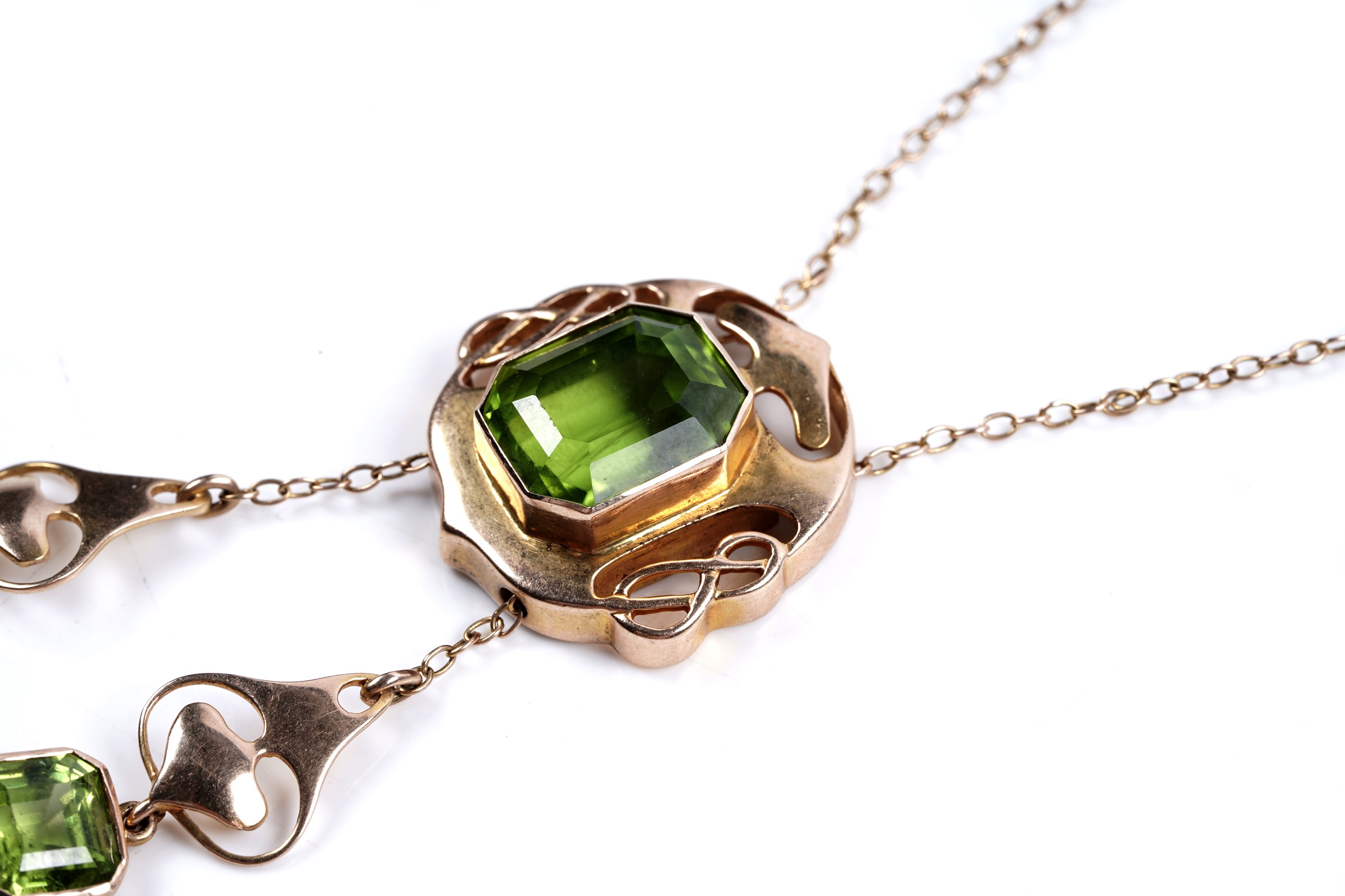 Lot 872 - An Arts and Crafts peridot and 15ct yellow